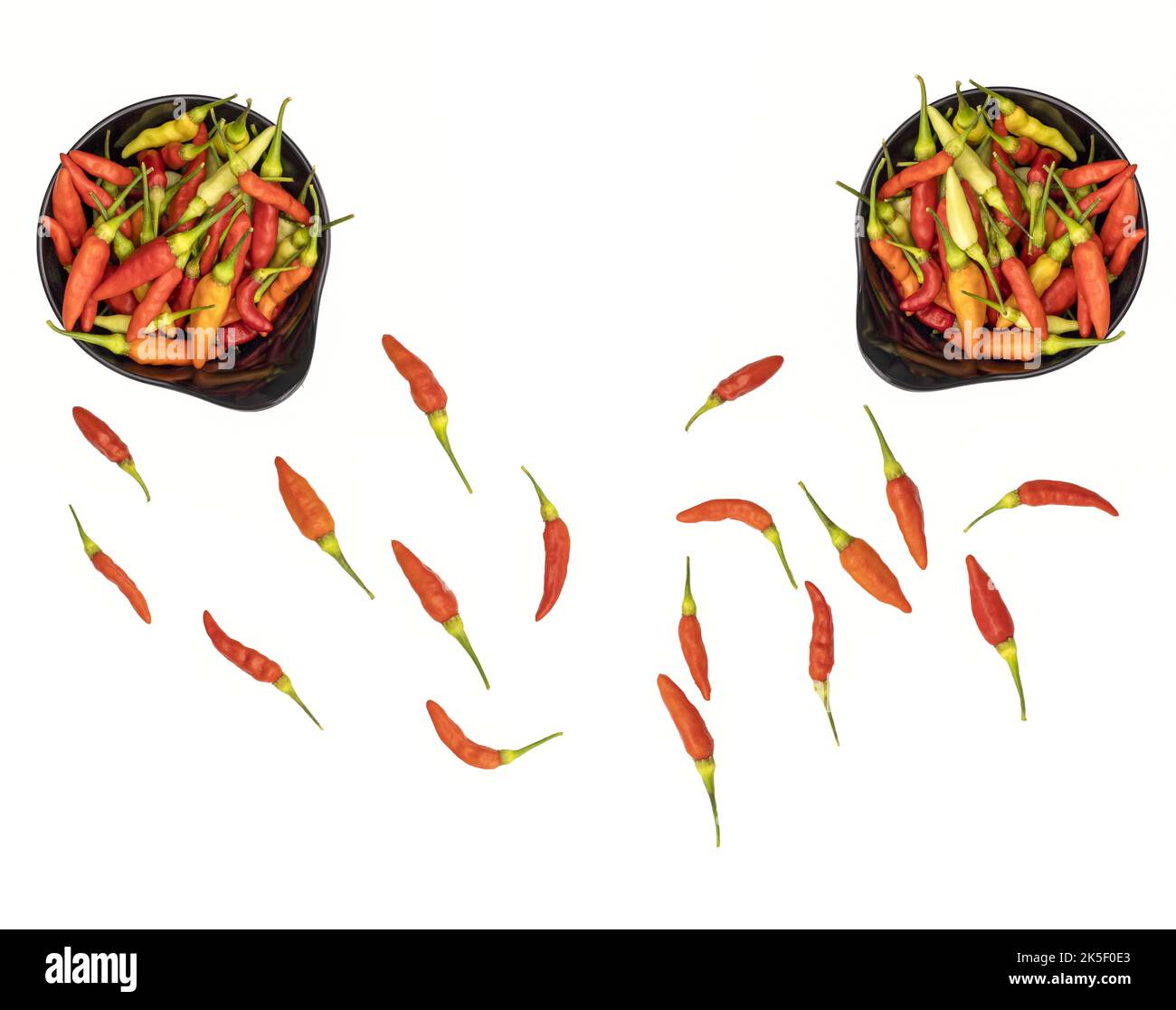 Colorful chili pepper in black bowl. Top View on white background Stock ...