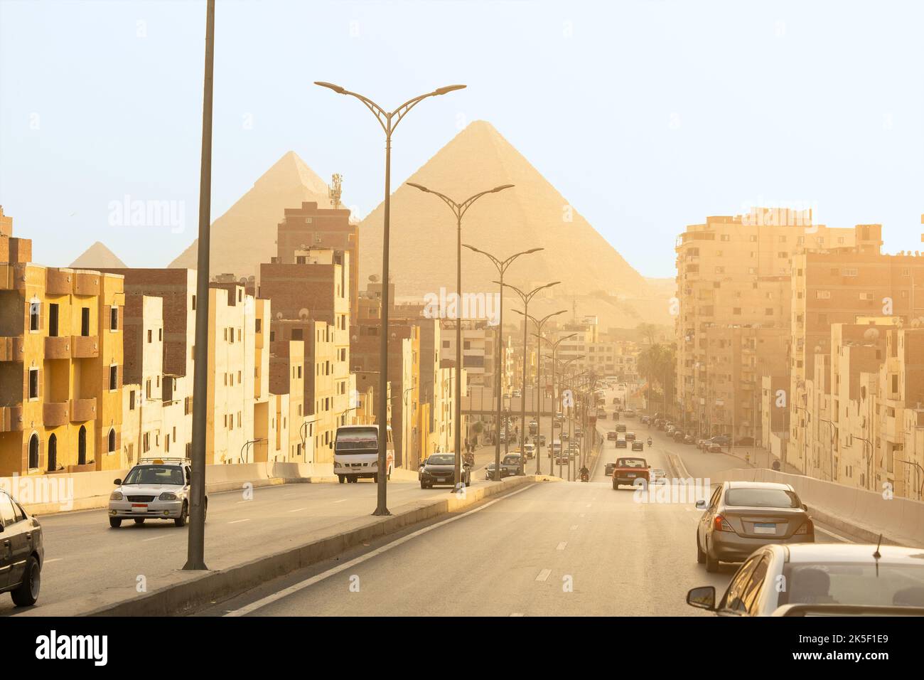 Cairo street with pyramids in the background Stock Photo - Alamy
