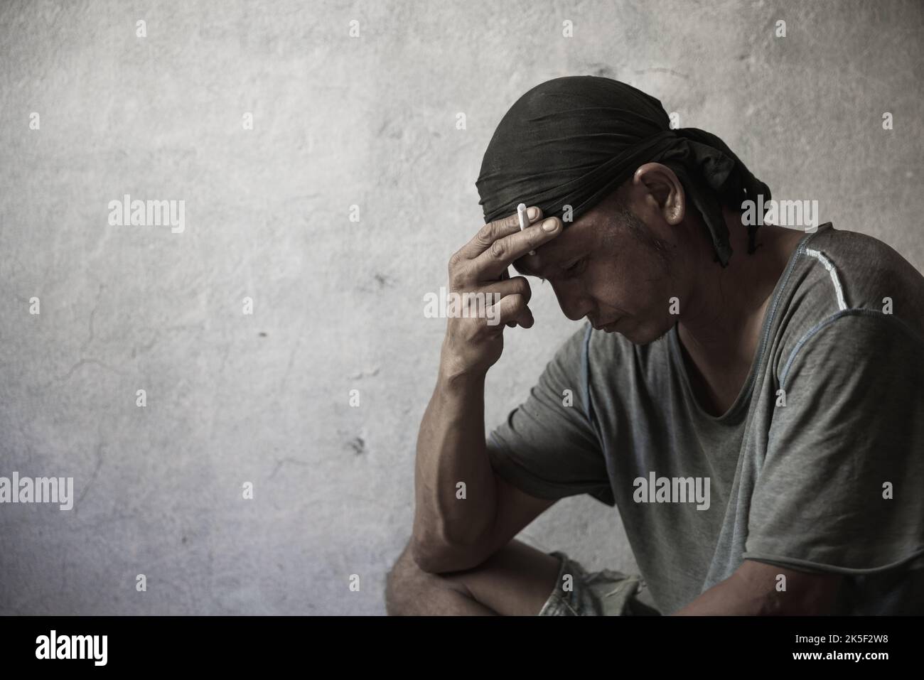 Men who show stress and loneliness, Homeless man drug addict sitting ...
