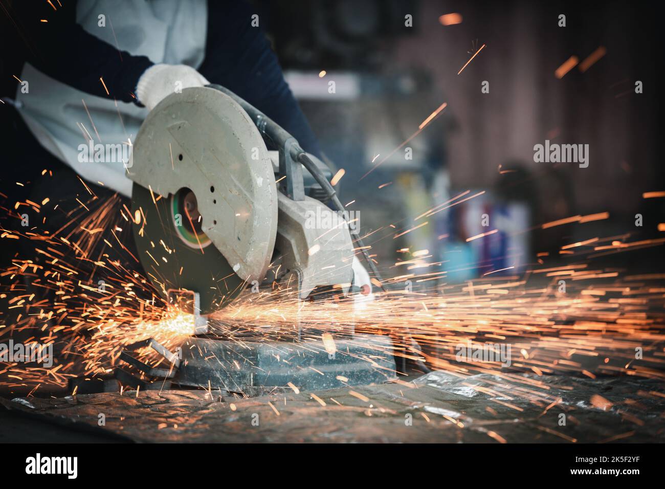 Cutting of a steel with splashes of sparks. Steel industry and workshop ...