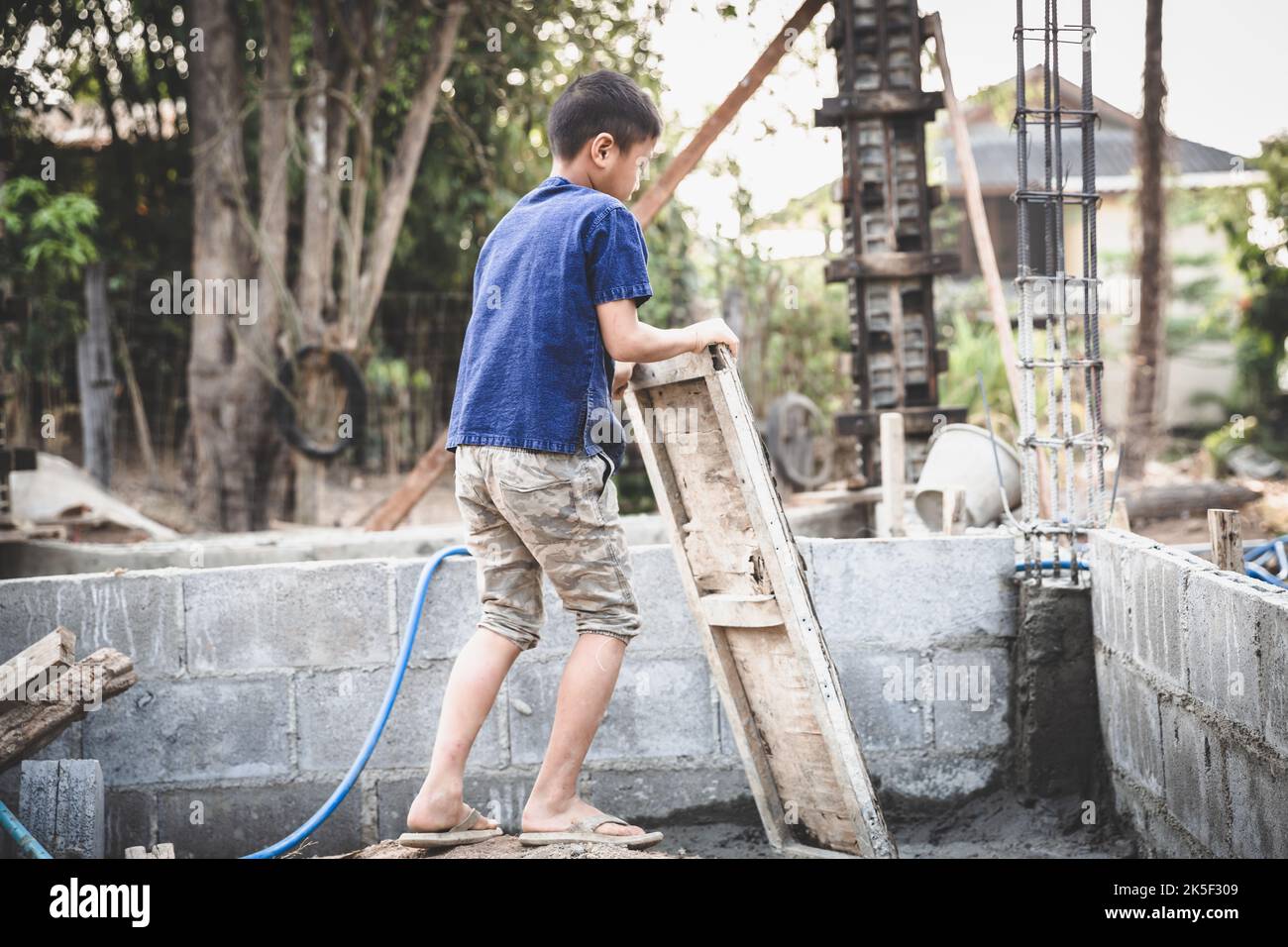 Poor children at the construction site were forced to work. Concept ...