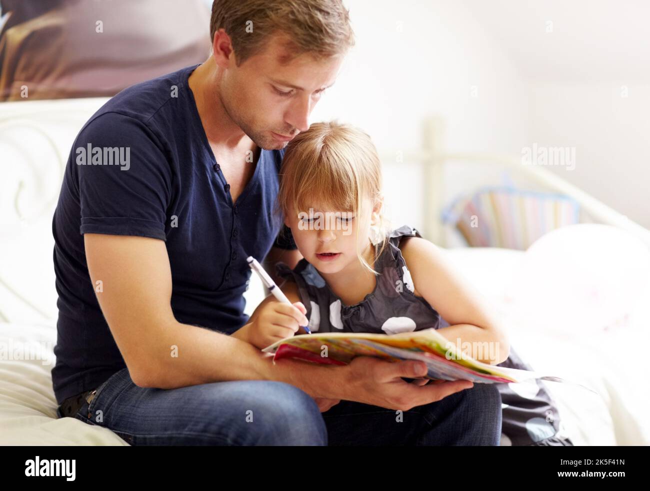 Father-daughter bonding. a young father bonding with his little ...