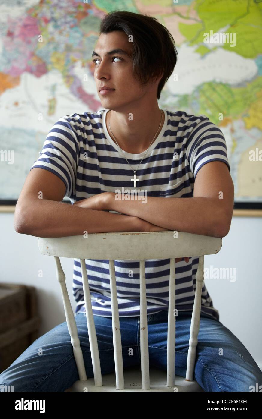 Contemplating his future. Trendy young guy looking away while thinking ...