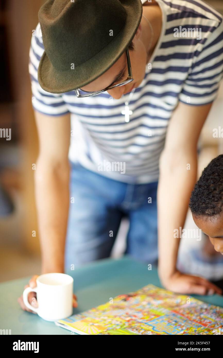 Time for a quick geography lesson. Young teachers aid looking at a map ...