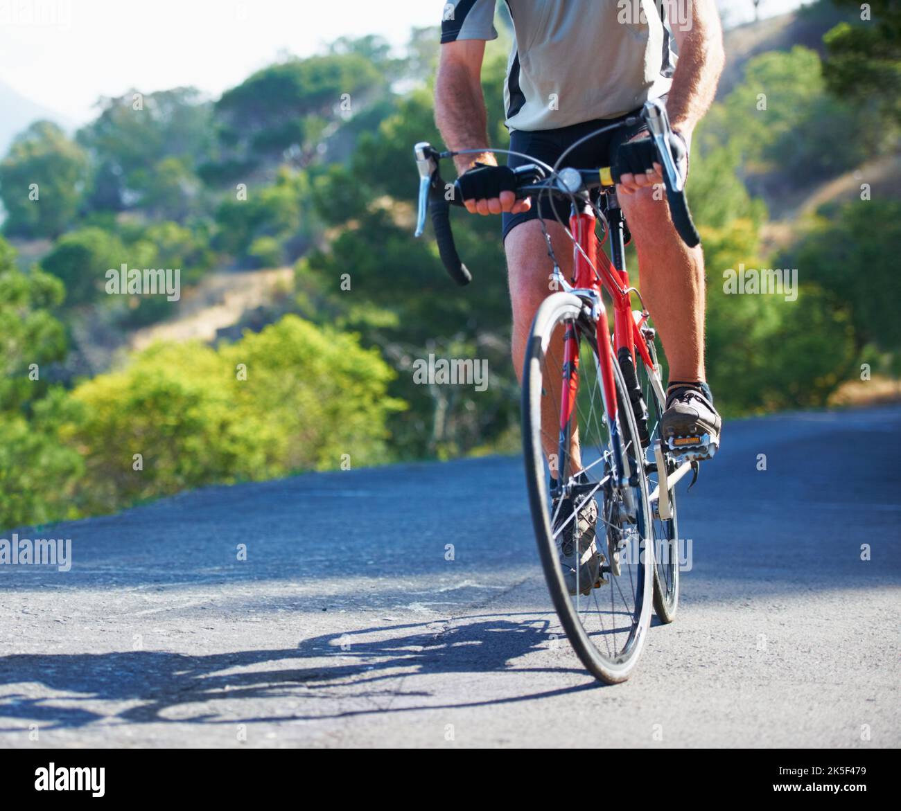 Person riding bike uphill hi-res stock photography and images - Alamy