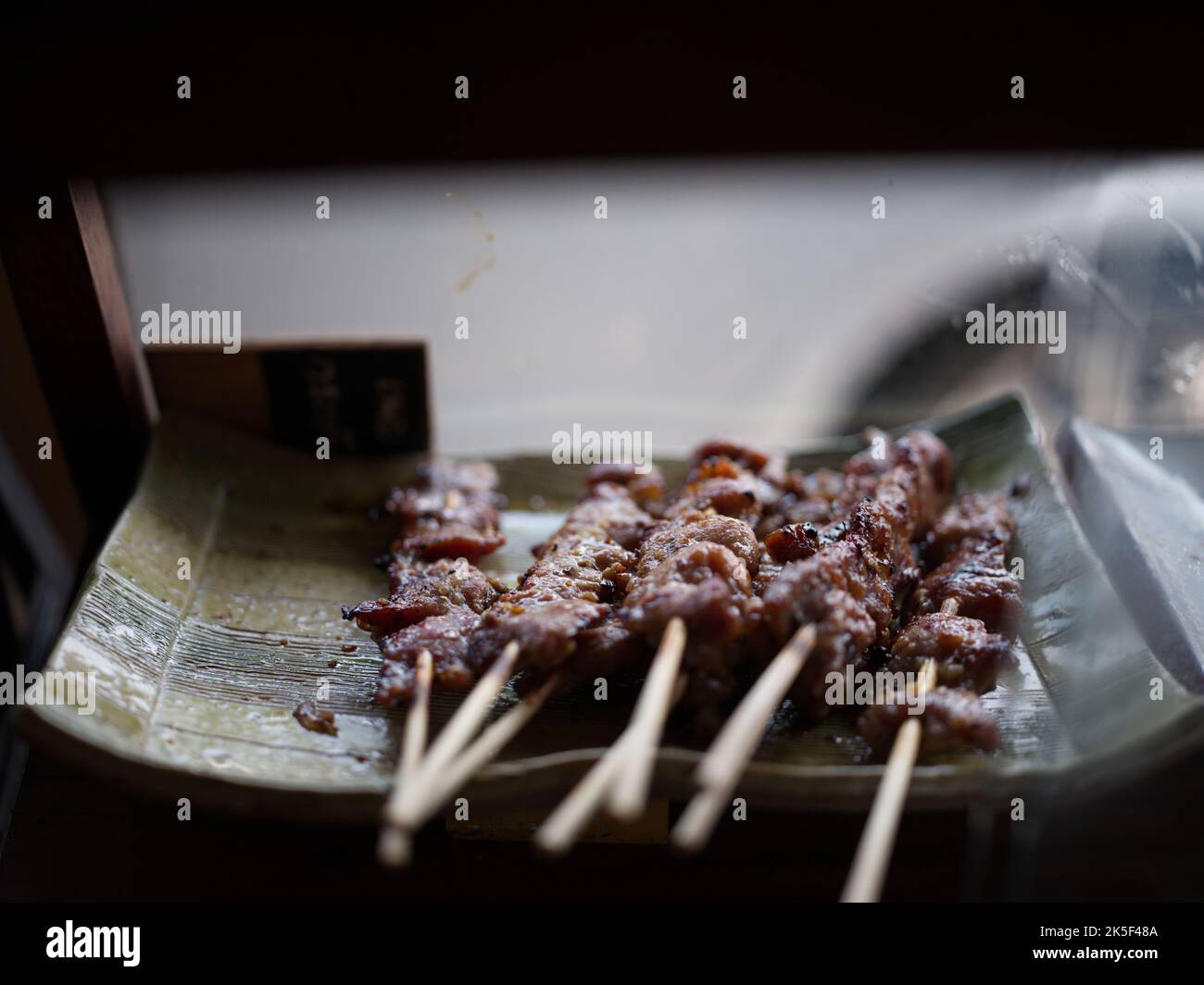 grilled pork sticks on fire flaming in steel stove vintage style ...