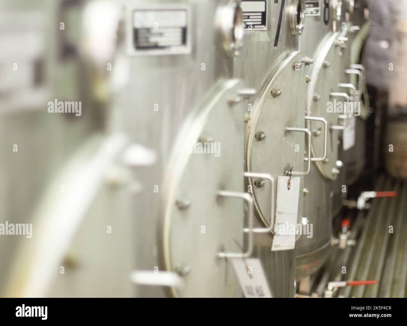 Inside the brewery. the stainless steel fermentation tanks for brewing ...