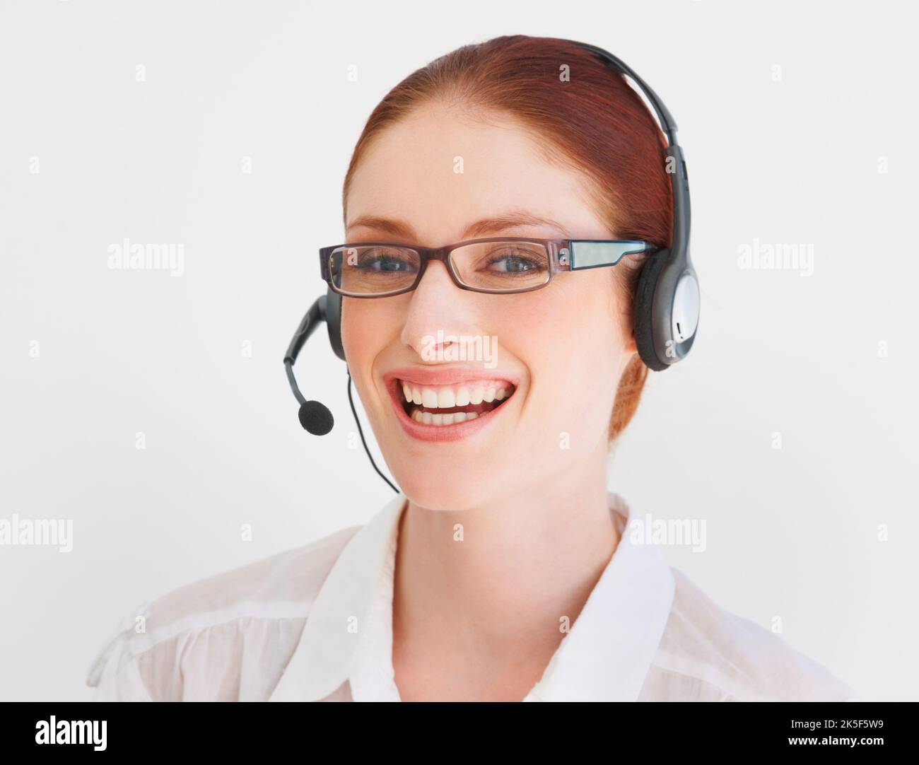 Hi, how can I help you. A young telemarketer speaking to a client Stock ...