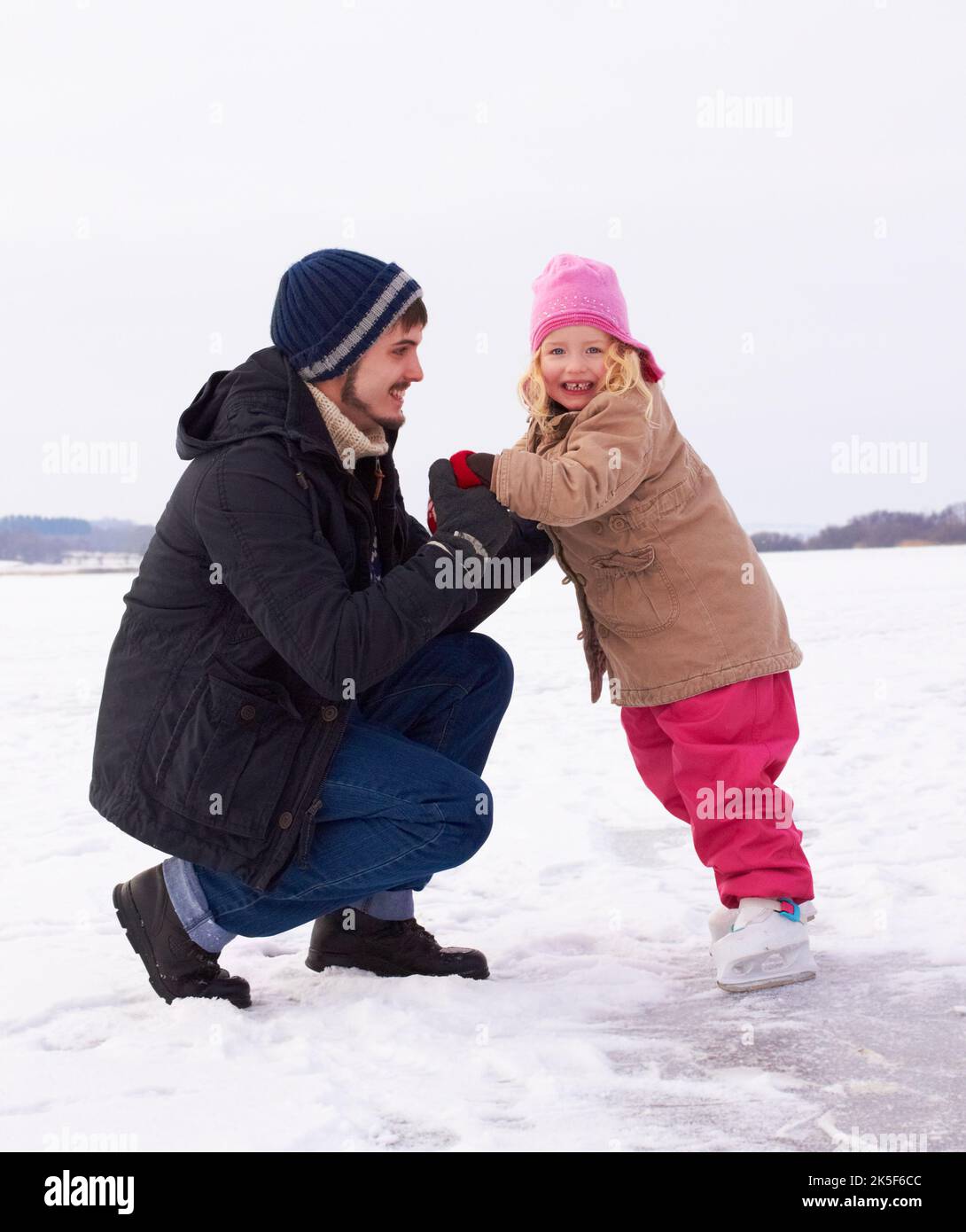 First outing on the ice. Older brother teaching his daughter how to ...