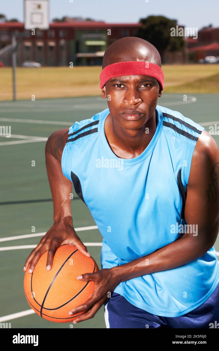 Practising some passes. A young basketball player dribbling a ball ...