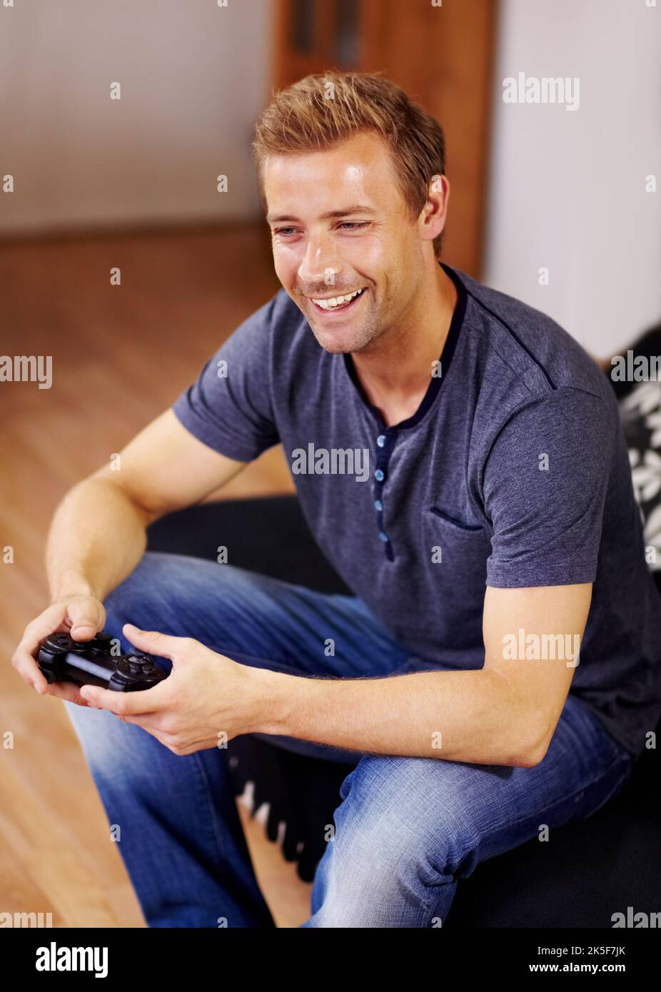 Im almost past this level. Handsome guy playing a video game using a ...