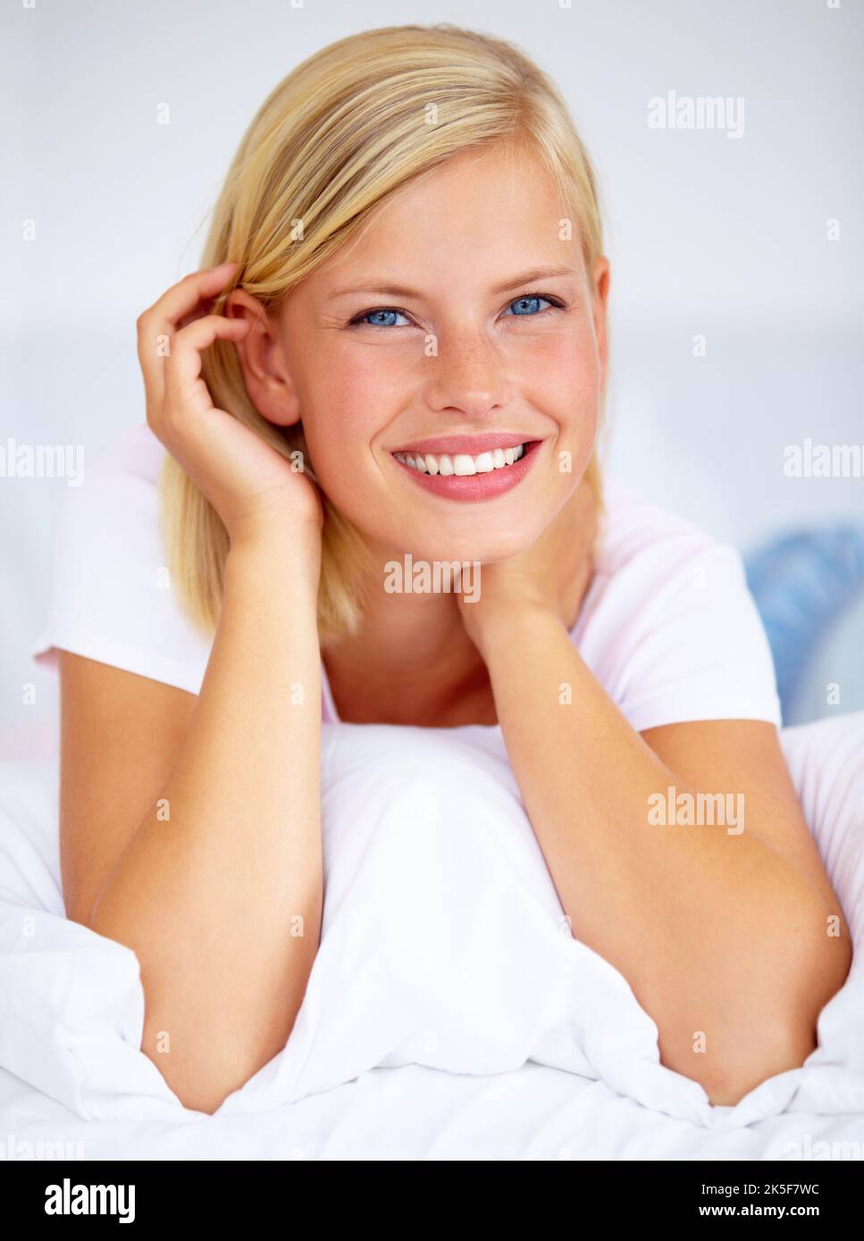 Shes happy and relaxed. Portrait of a beautiful young woman lying on ...