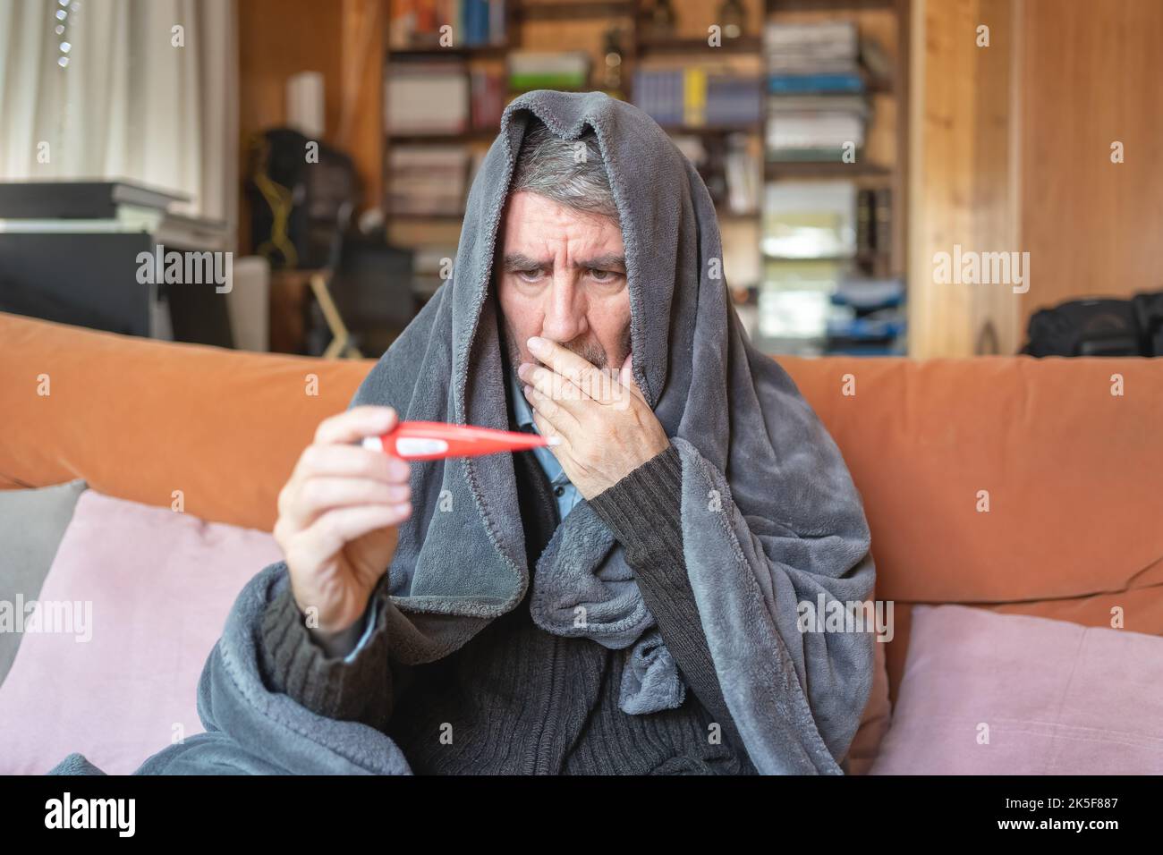 Sad man checking temperature hi-res stock photography and images - Alamy