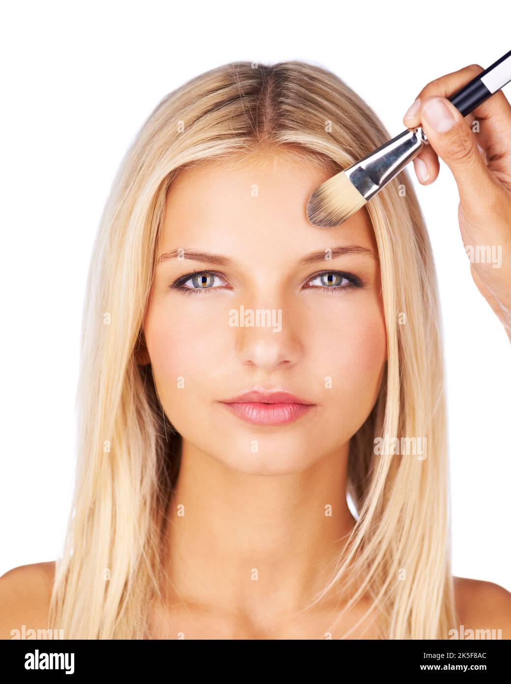 Perfect skin with just a dab. Cropped view of a young woman having ...