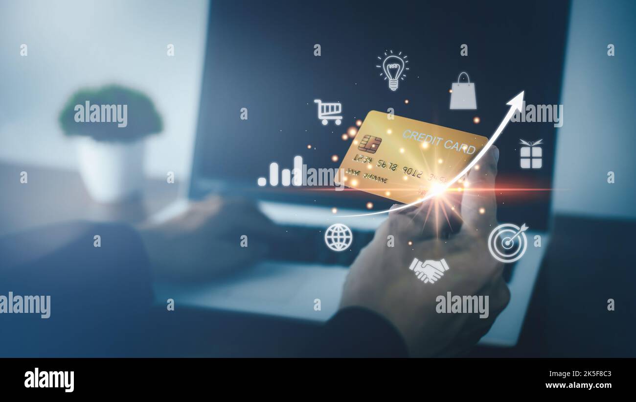 Online payment with credit card technology. Businessman hand hold gold ...