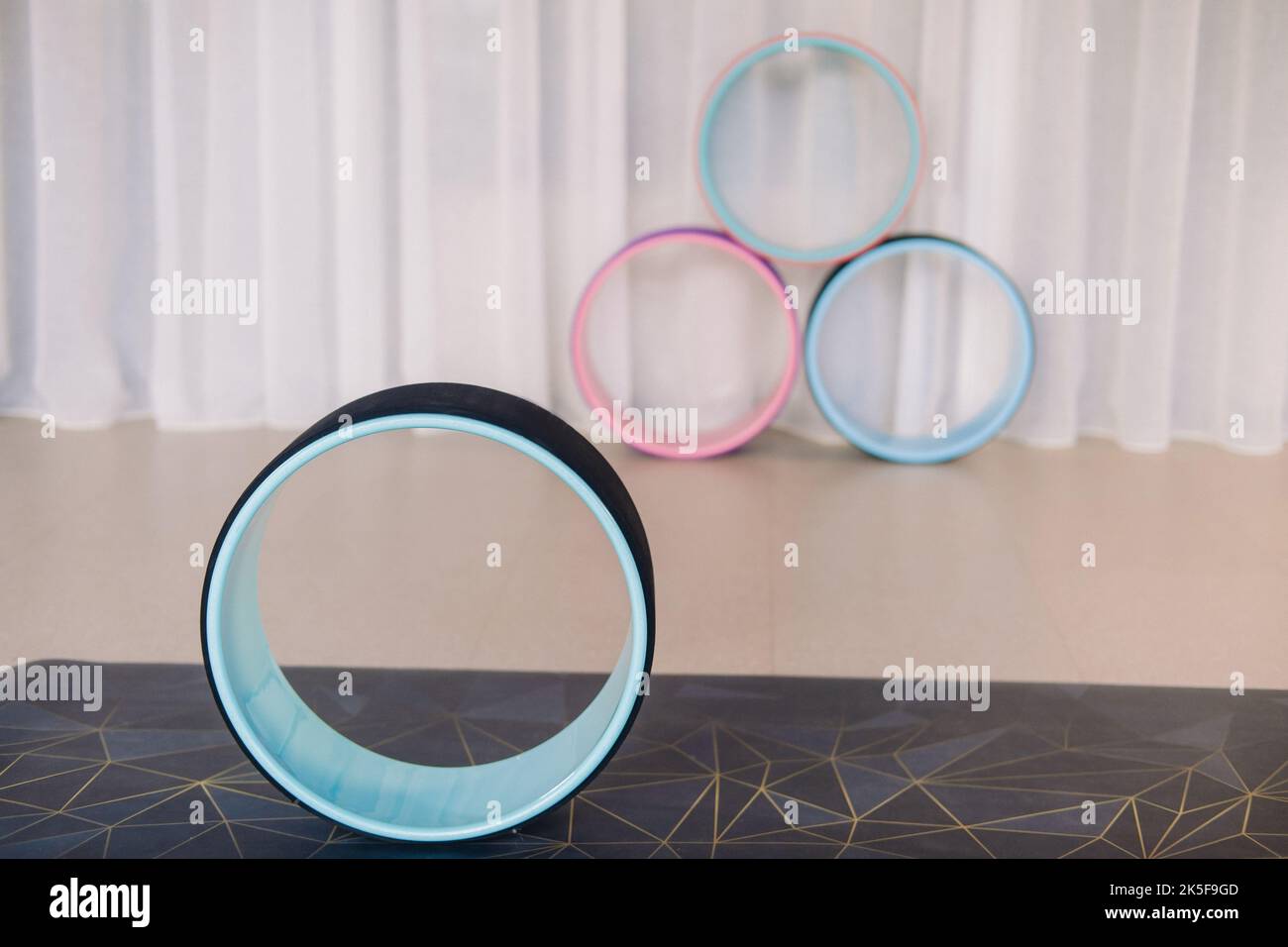 a set of yoga wheels lying on the mat. Fitness Equipment Pilates Ring ...