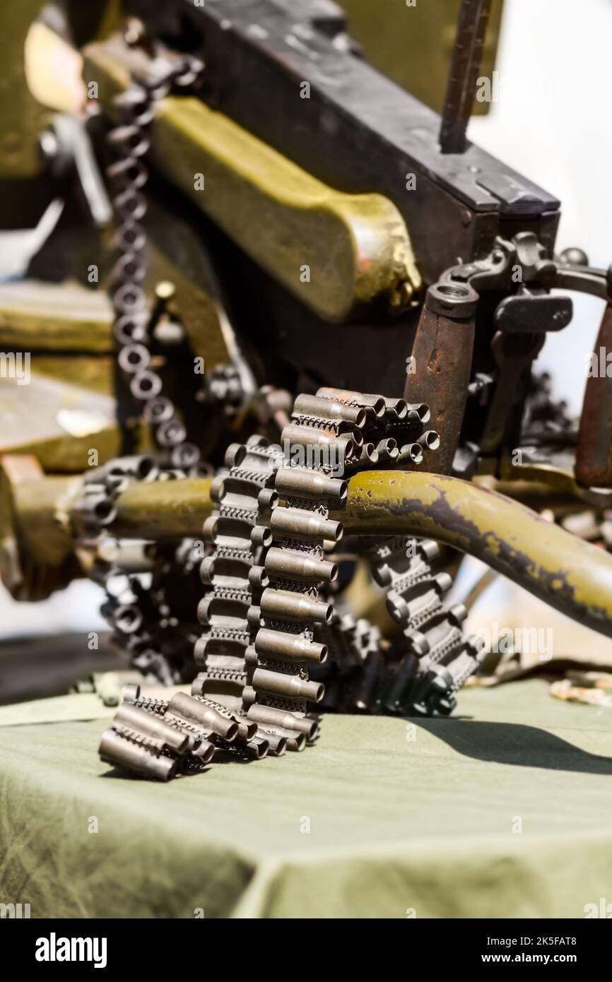 Weapons of destruction. a machine gun and bullet rounds Stock Photo - Alamy