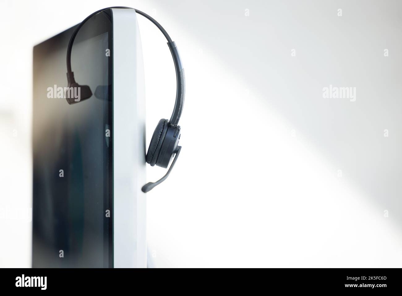 Computer, headphones and call center telemarketing background in office ...