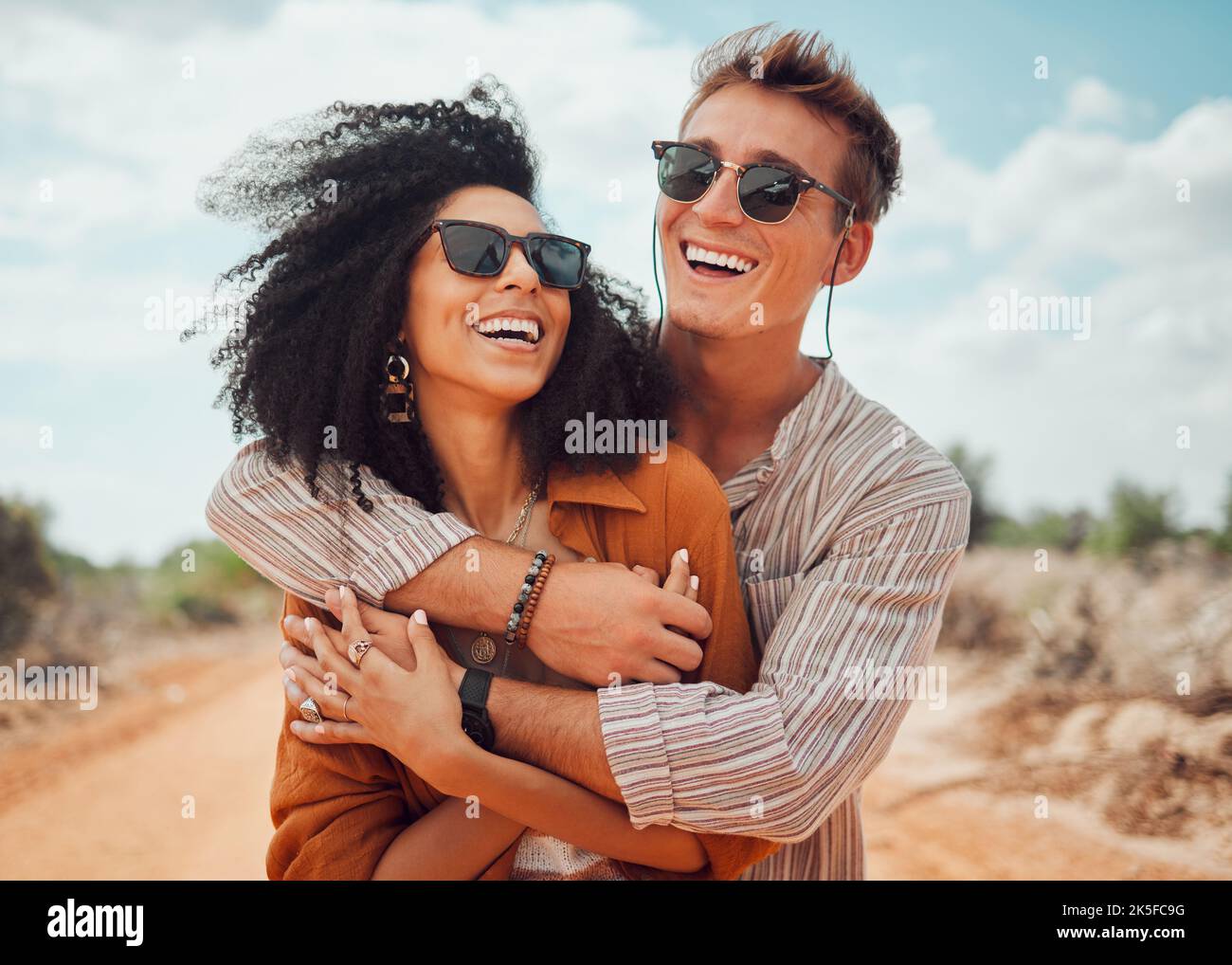 Couple, happy and smile hug in nature on a travel, adventure and road ...