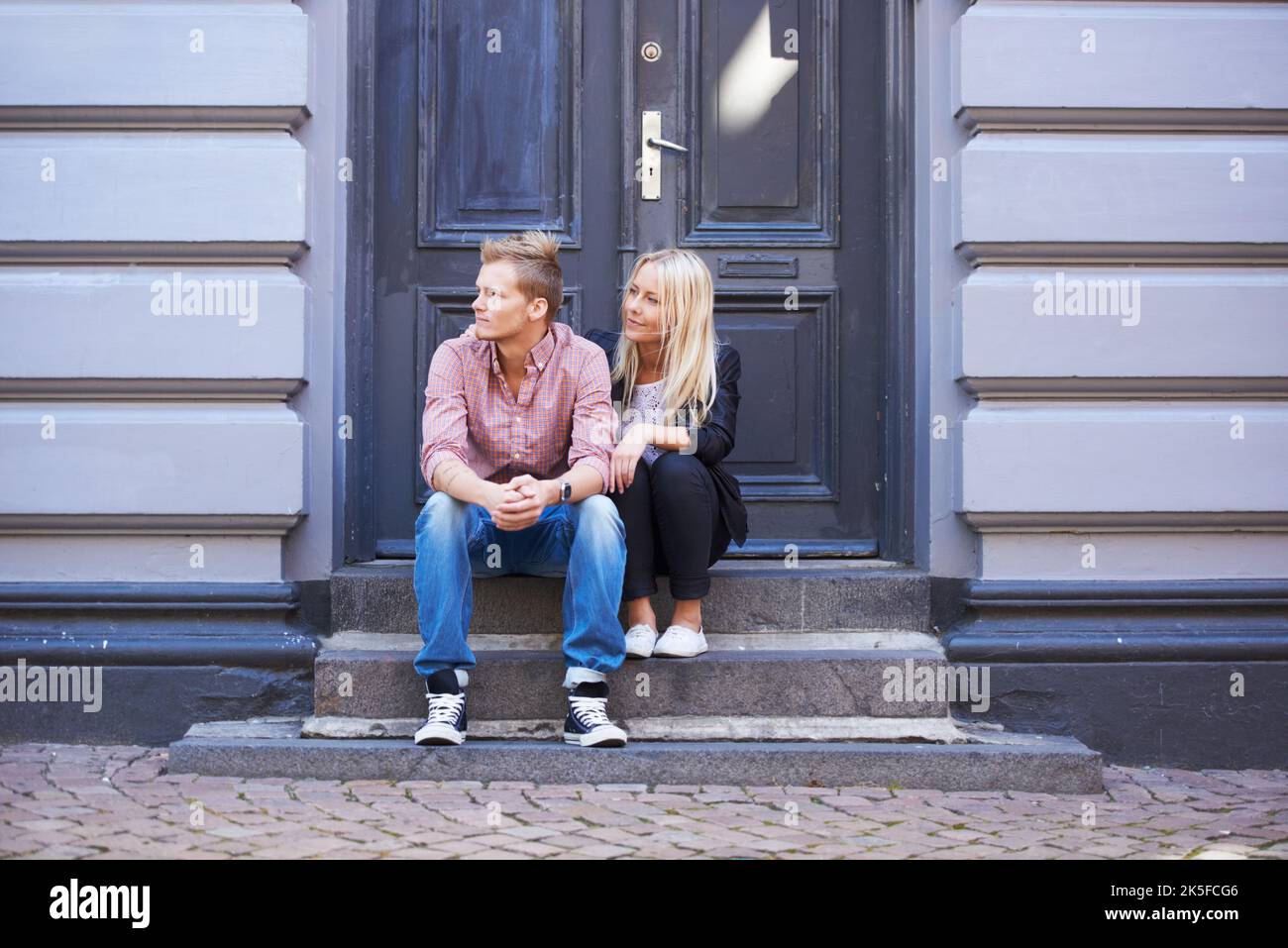 A woman sitting on doorstep hi-res stock photography and images - Alamy