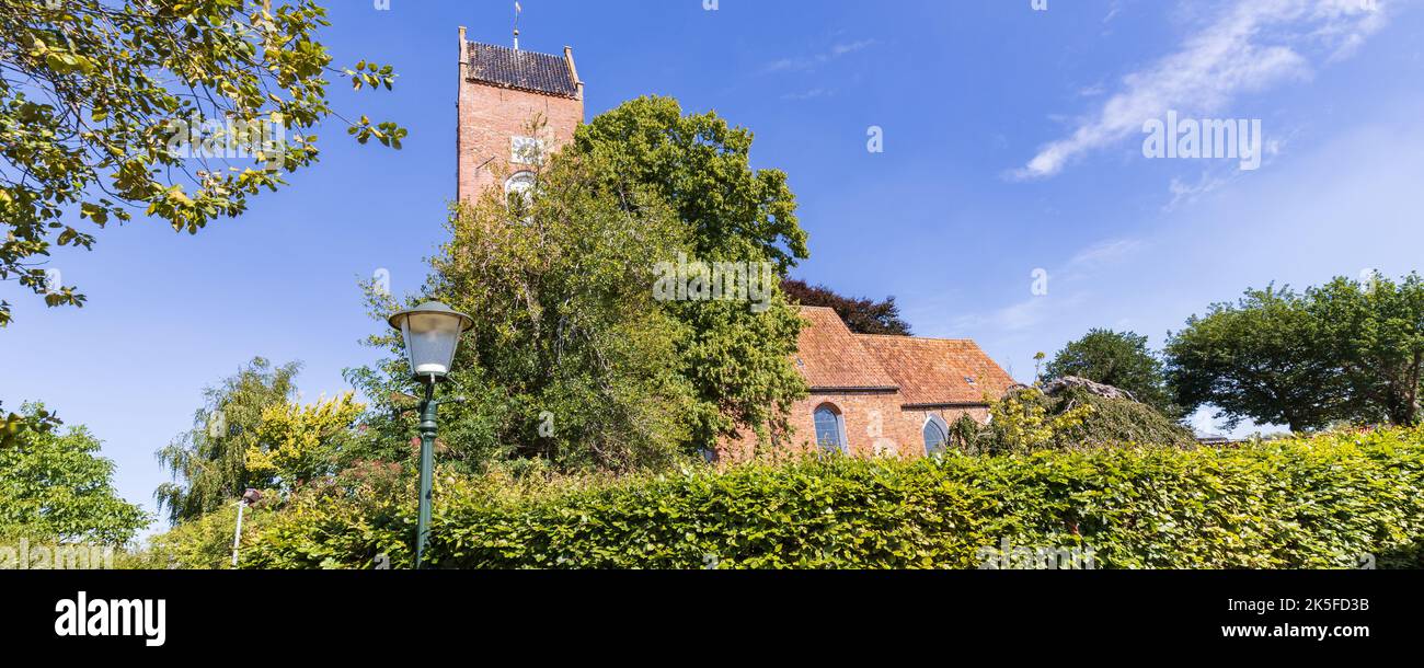 Classic church from 13th century surrounded by big trees in Tolbert ...