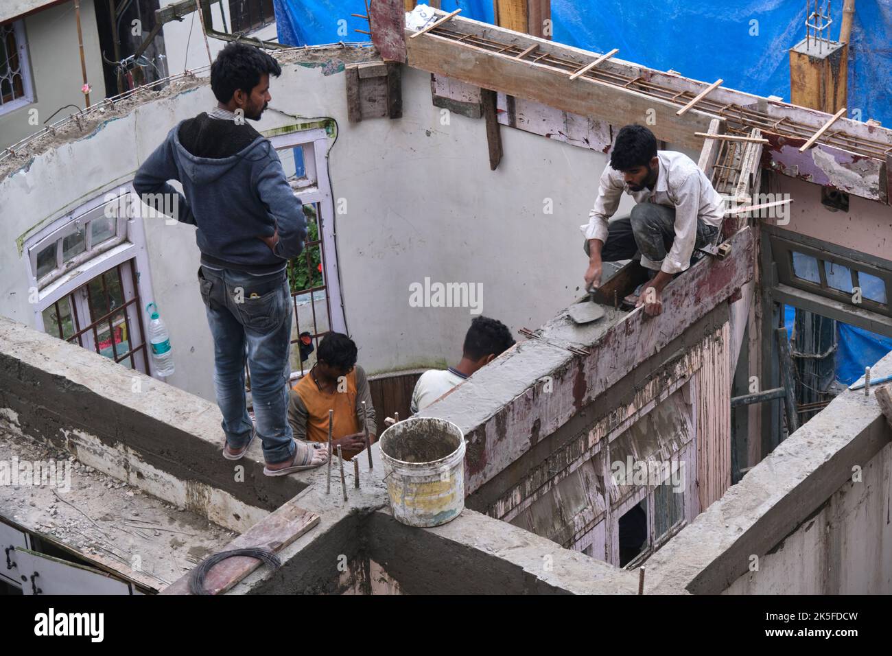 22 June 2022, Darjeeling, India, undefined construction worker constructing or building wall by ...