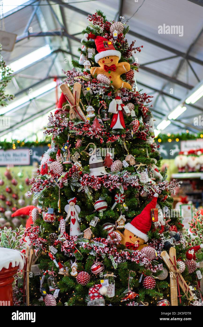 Christmas tree packed with decorations and novelties on display in a ...