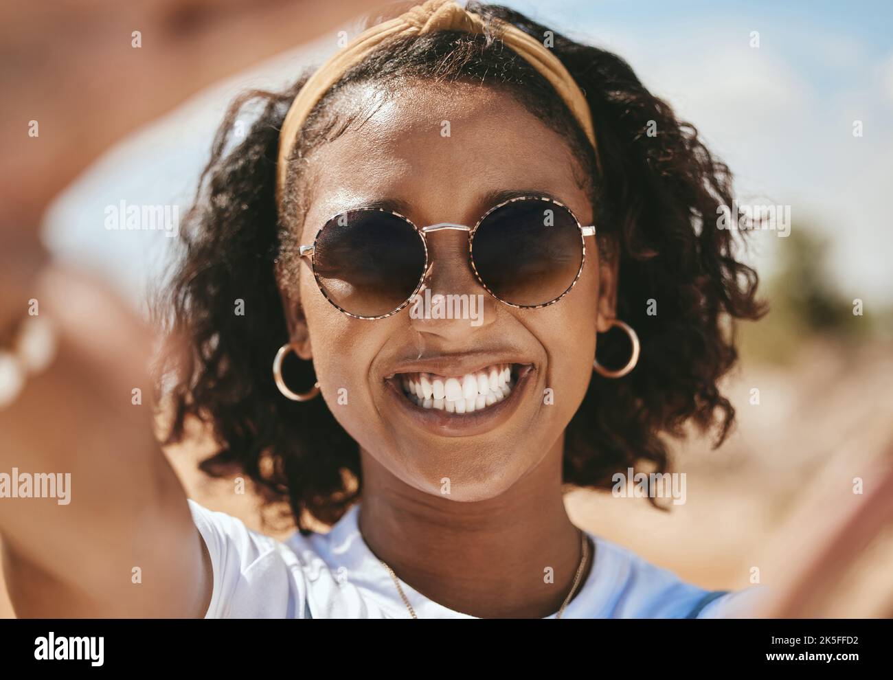 Hand frame, portrait and black woman with smile on holiday in nature of ...