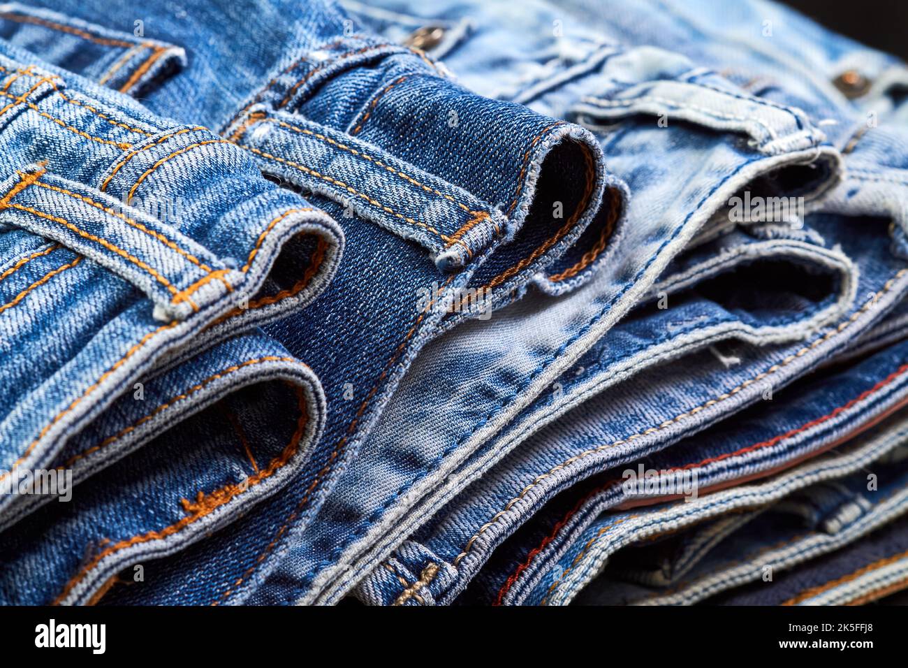 A stack of jeans as denim background or concept of buying, selling ...