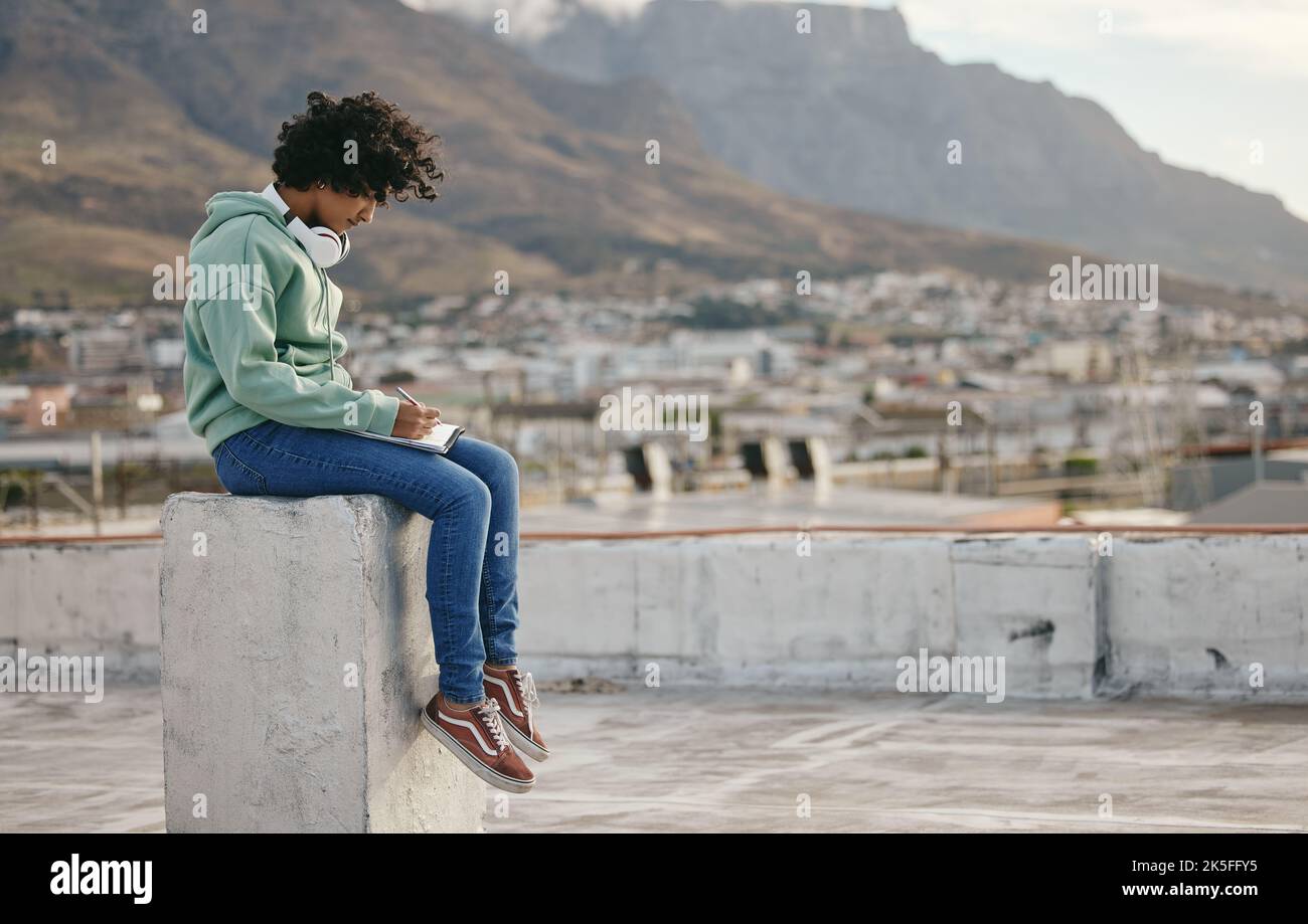 Freedom, book and writing girl on outdoor rooftop for diary inspiration ...