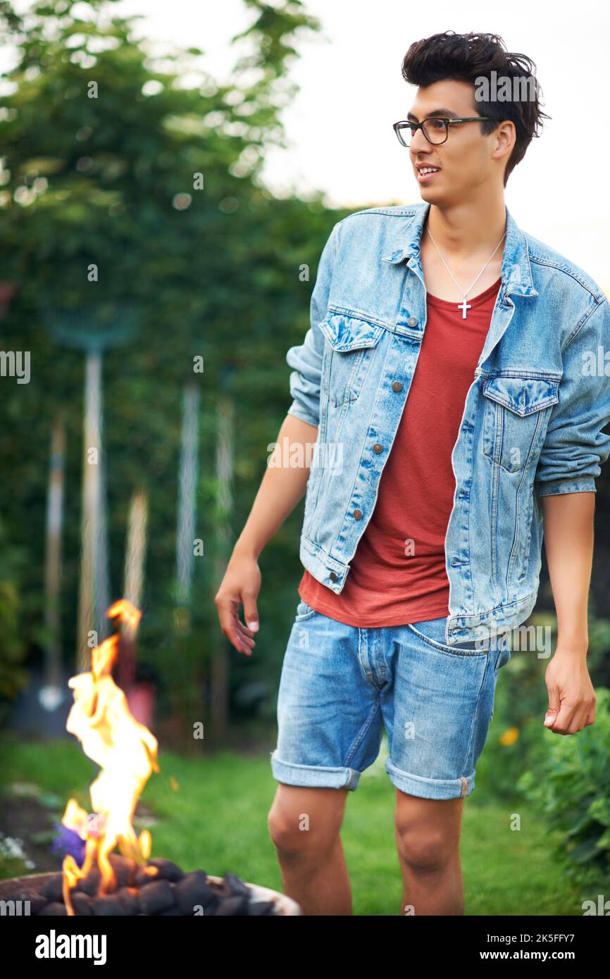 Going on a camping trip. Handsome young guy standing outside near a ...