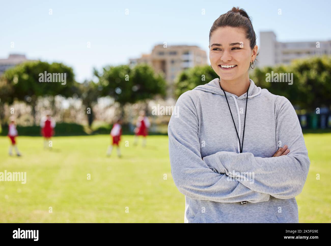 Sports, soccer and coaching with woman on football field with arms ...