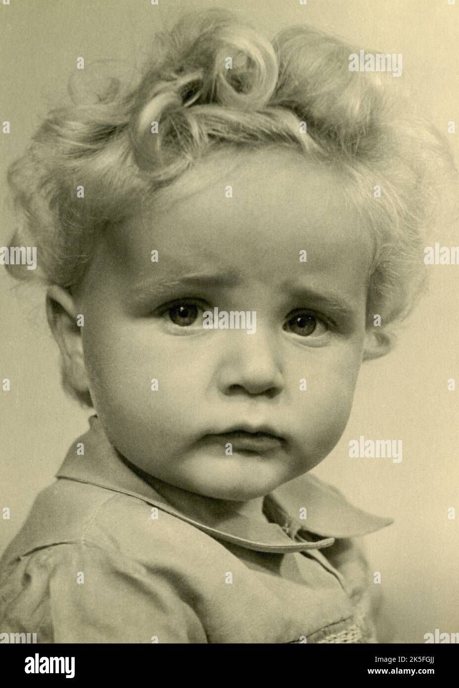 Questioning and quizzical stare from a curly haired little girl in the ...