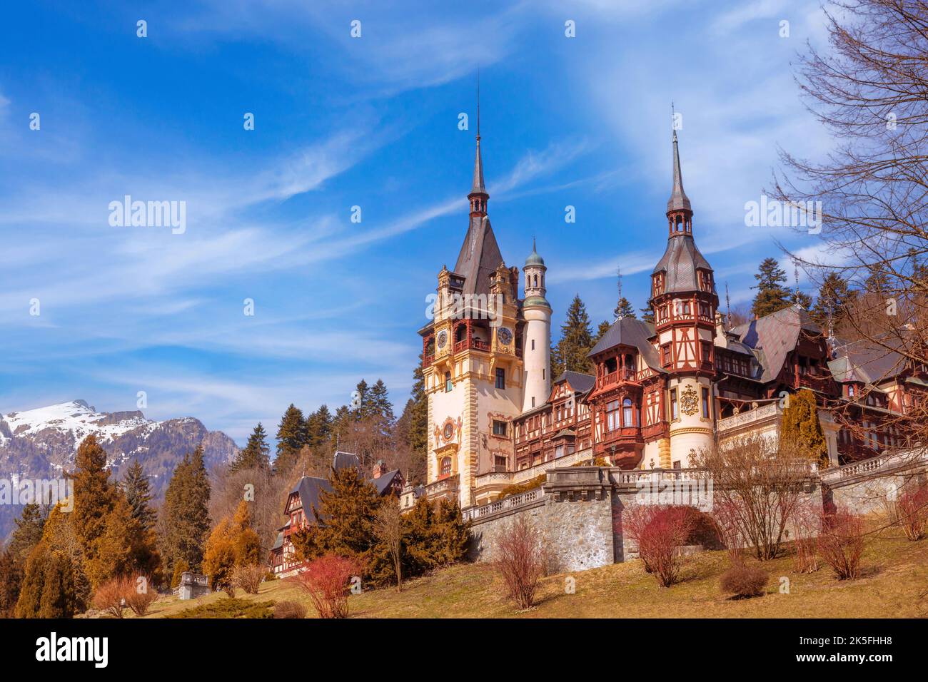 Peles castle close-up view and Carpathian mountains snow peaks, Sinaia ...