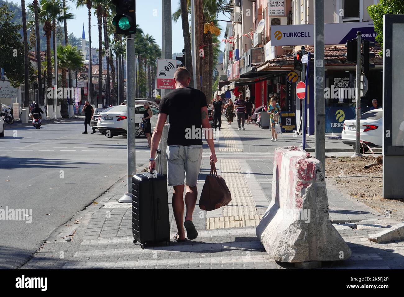 Fethiye daily life, tourist carry luggage Stock Photo - Alamy