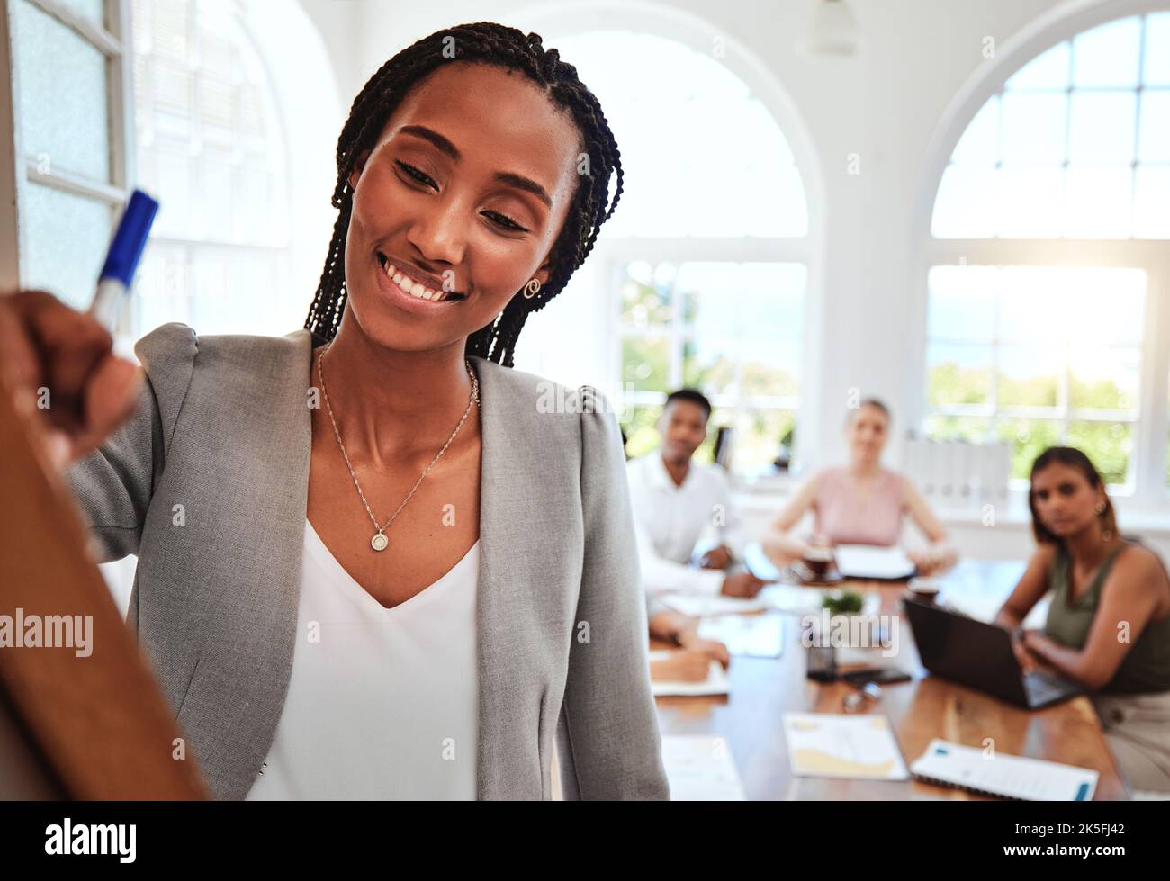 Team, black woman and brainstorming writing on board for team meeting ...
