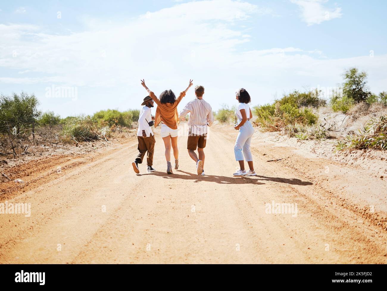 Freedom, desert and friends walking outdoor in nature on a road trip ...