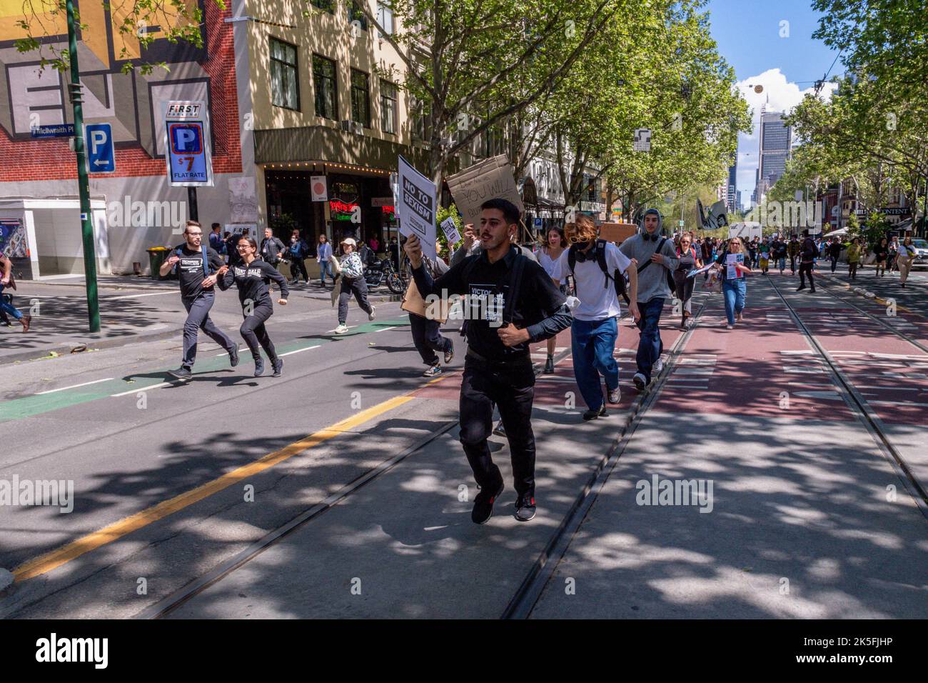 Left wing protesters run along Bourke Street during the counter rally ...