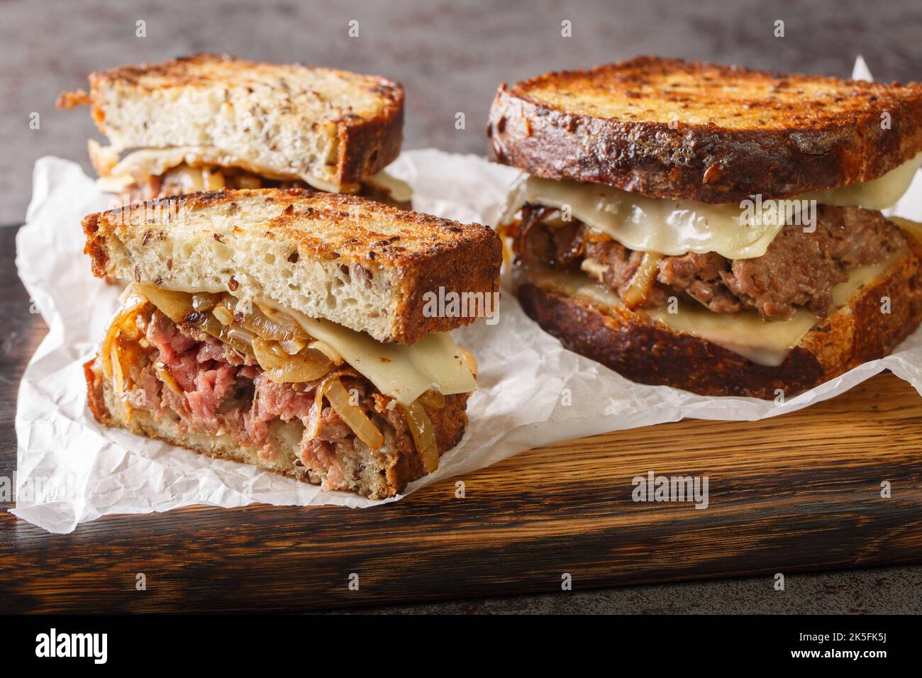 classic beef patty melt sandwich using crispy rye bread, cheese, and ...