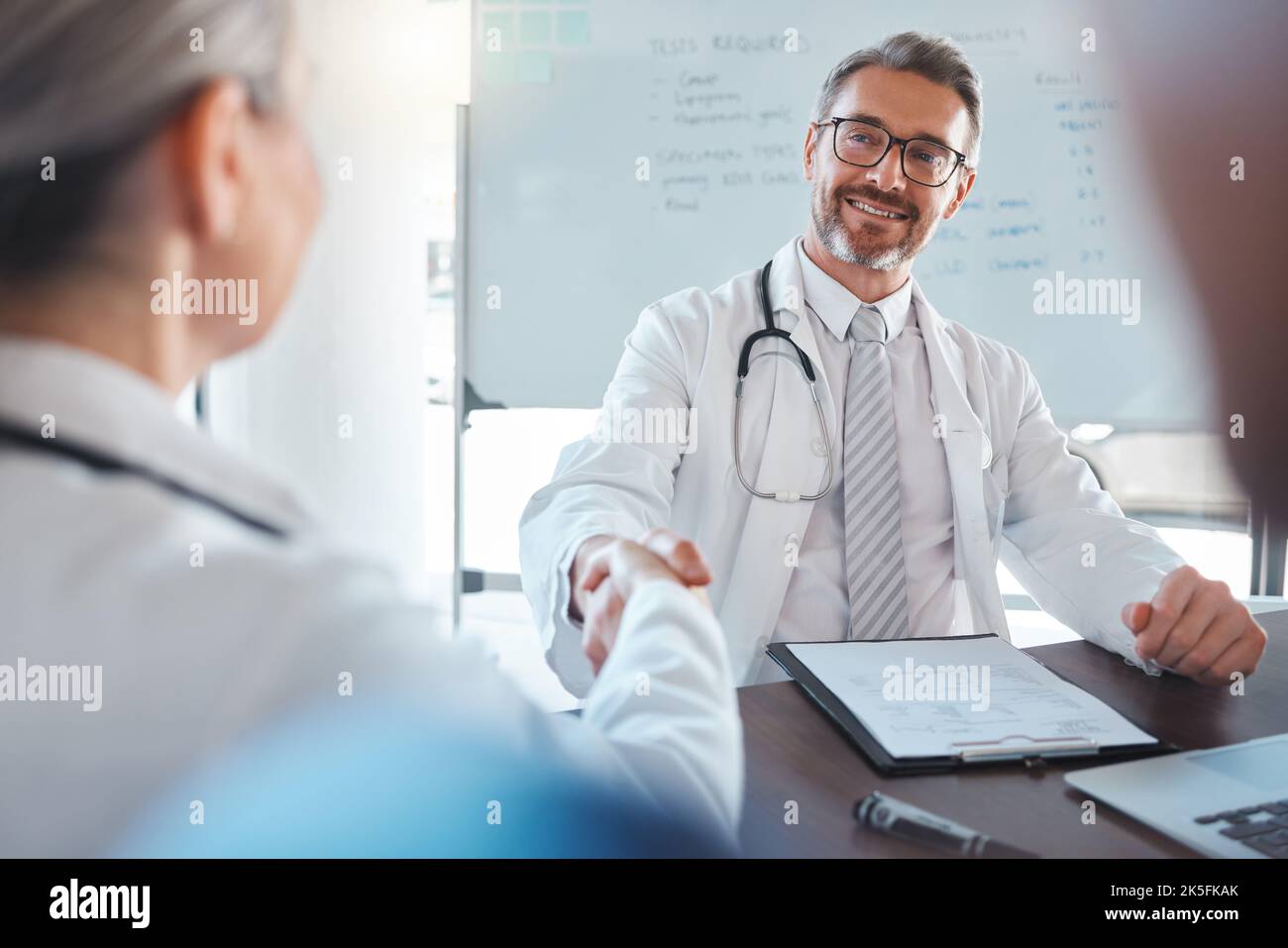 Doctor handshake, medical welcome and man consulting with team for ...
