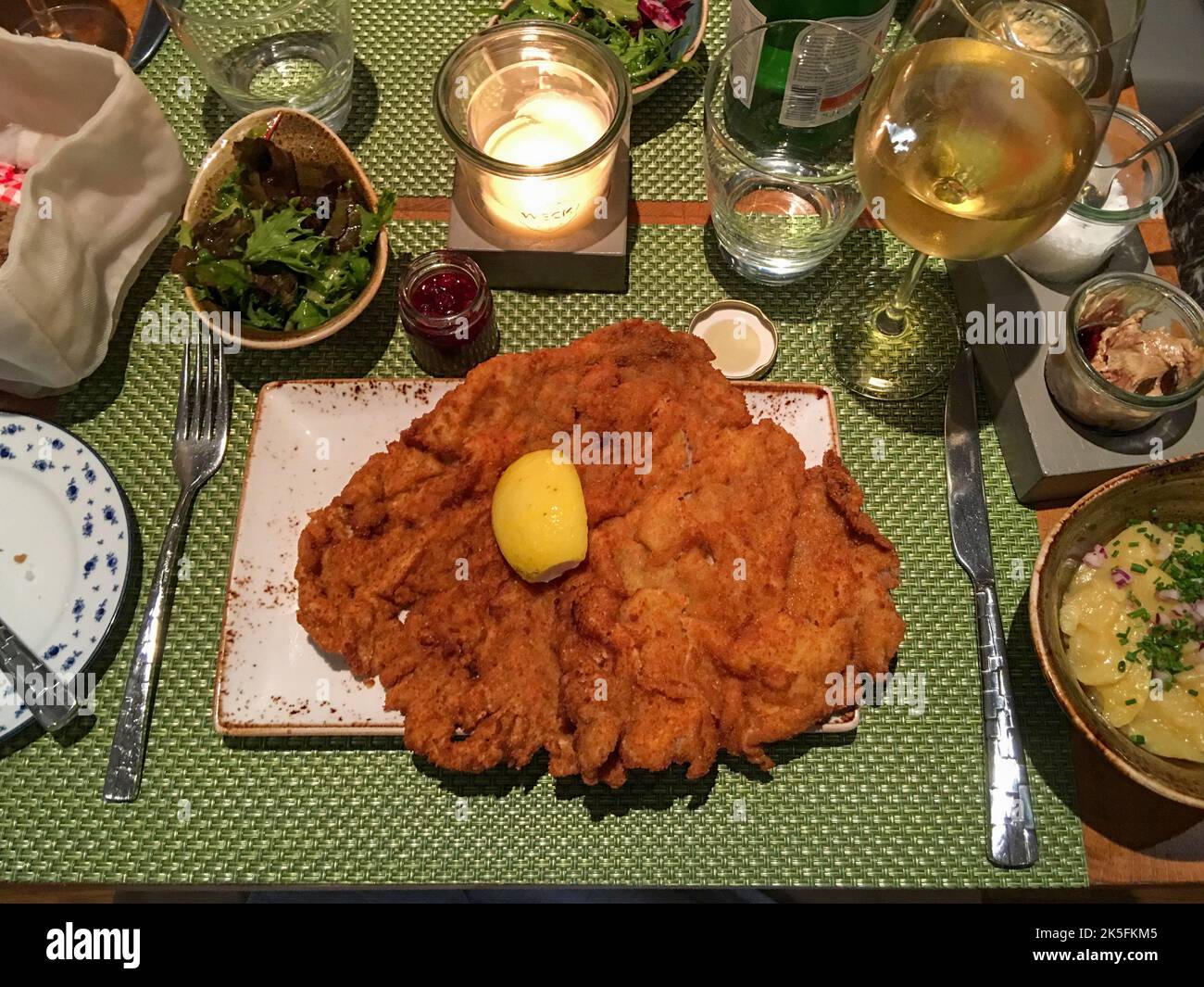 Traditional Austrian schnitzel dinner at fullt table Stock Photo - Alamy
