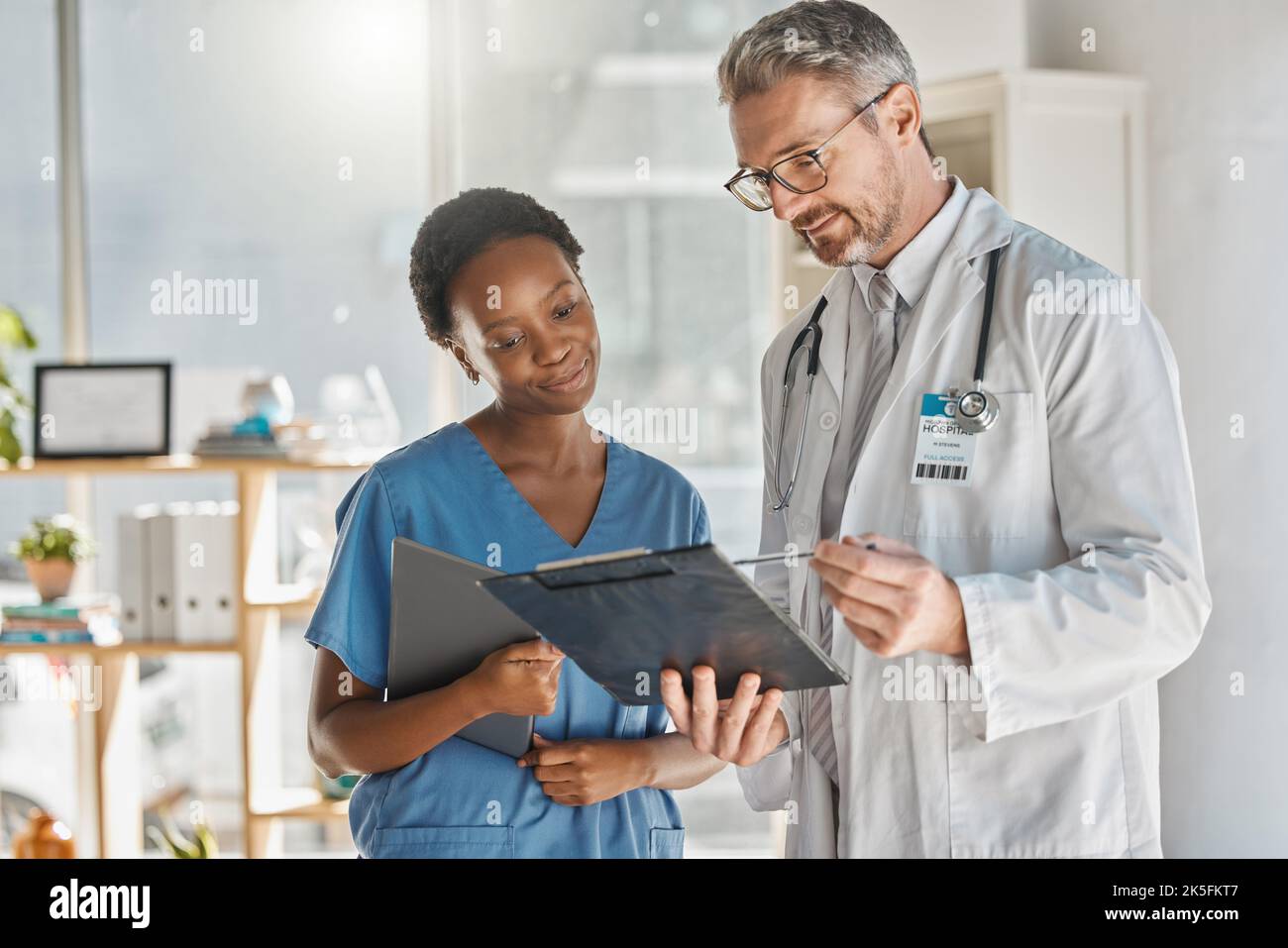 Student nurse and doctor document review in hospital for professional ...