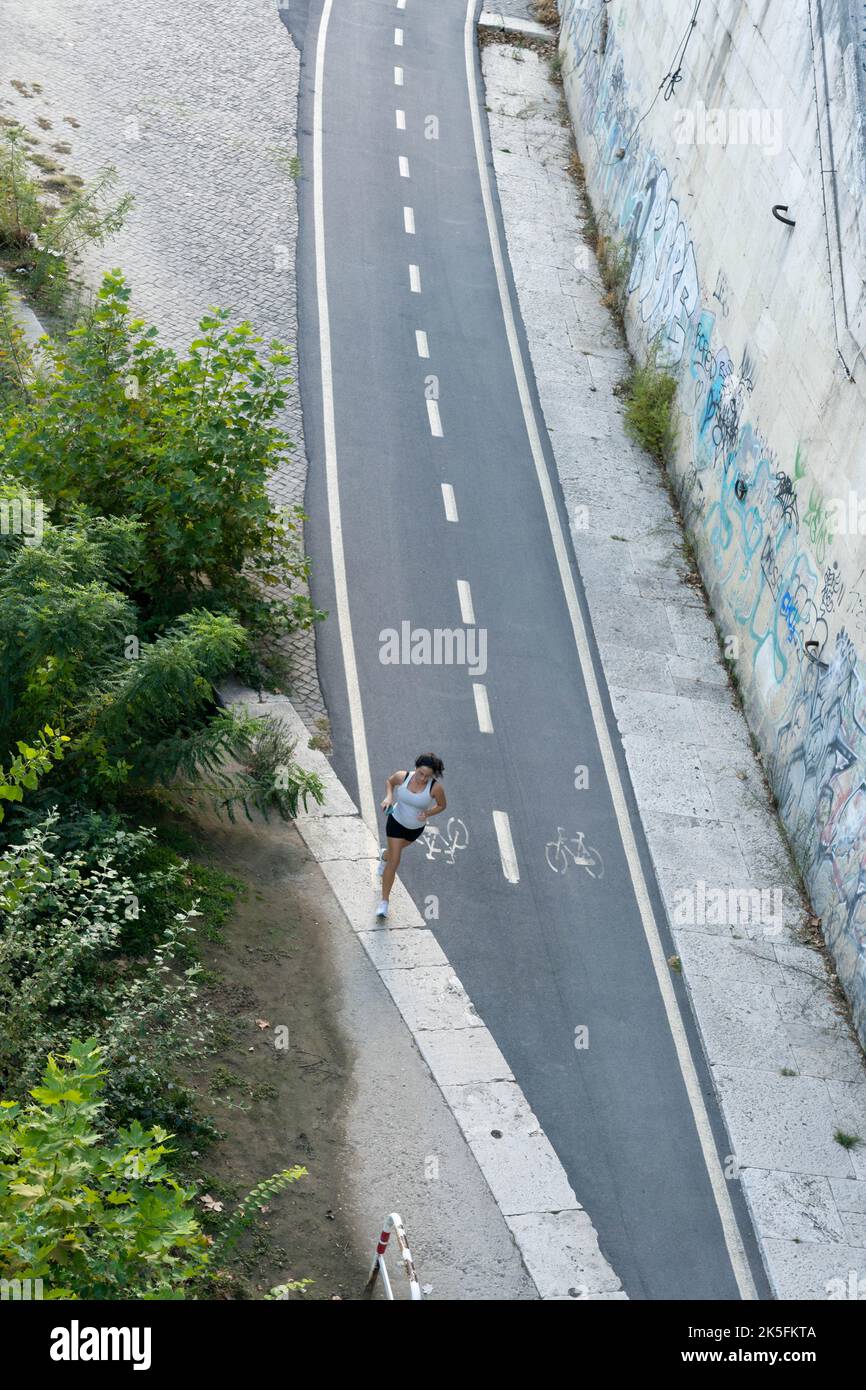 Aerial view of female jogger running along cycle path in Rome Stock ...