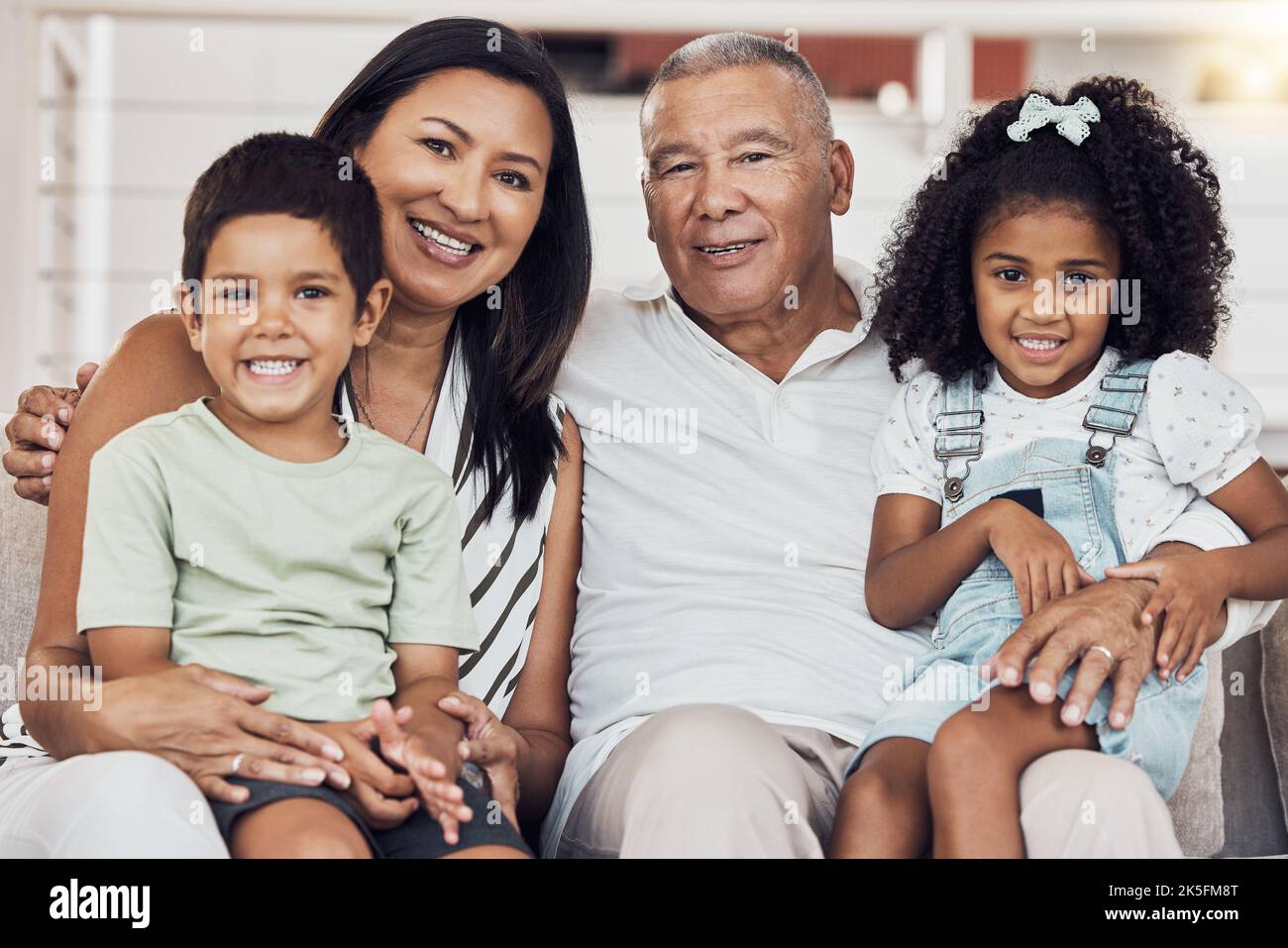 Love, grandparents or children bond on sofa in house or home living ...