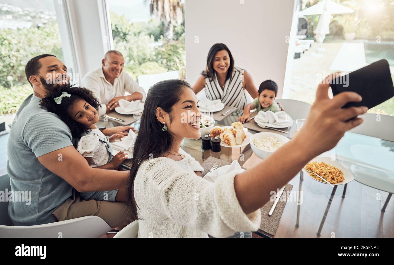 Big family, phone selfie and food in home, eating and spending time ...