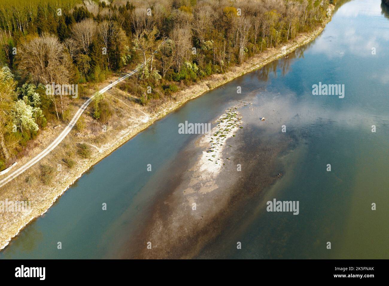 An aerial view of Salzach river in Salzburg surrounded by greenery on a ...