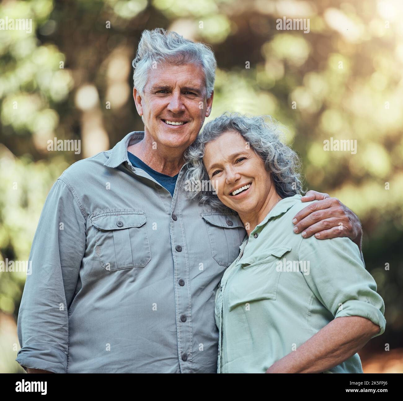 Senior couple, love and hug in nature together for support, care and ...