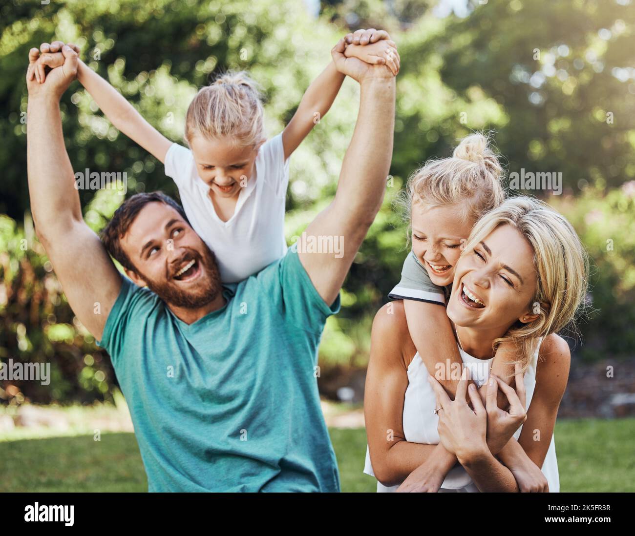 Love, happy and family playing in a park, laugh and relax while having ...
