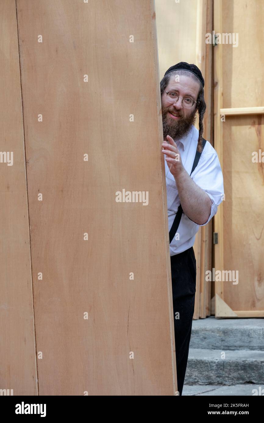 In preparation for the Sukkos holiday, an orthodox Jewish man builds a ...