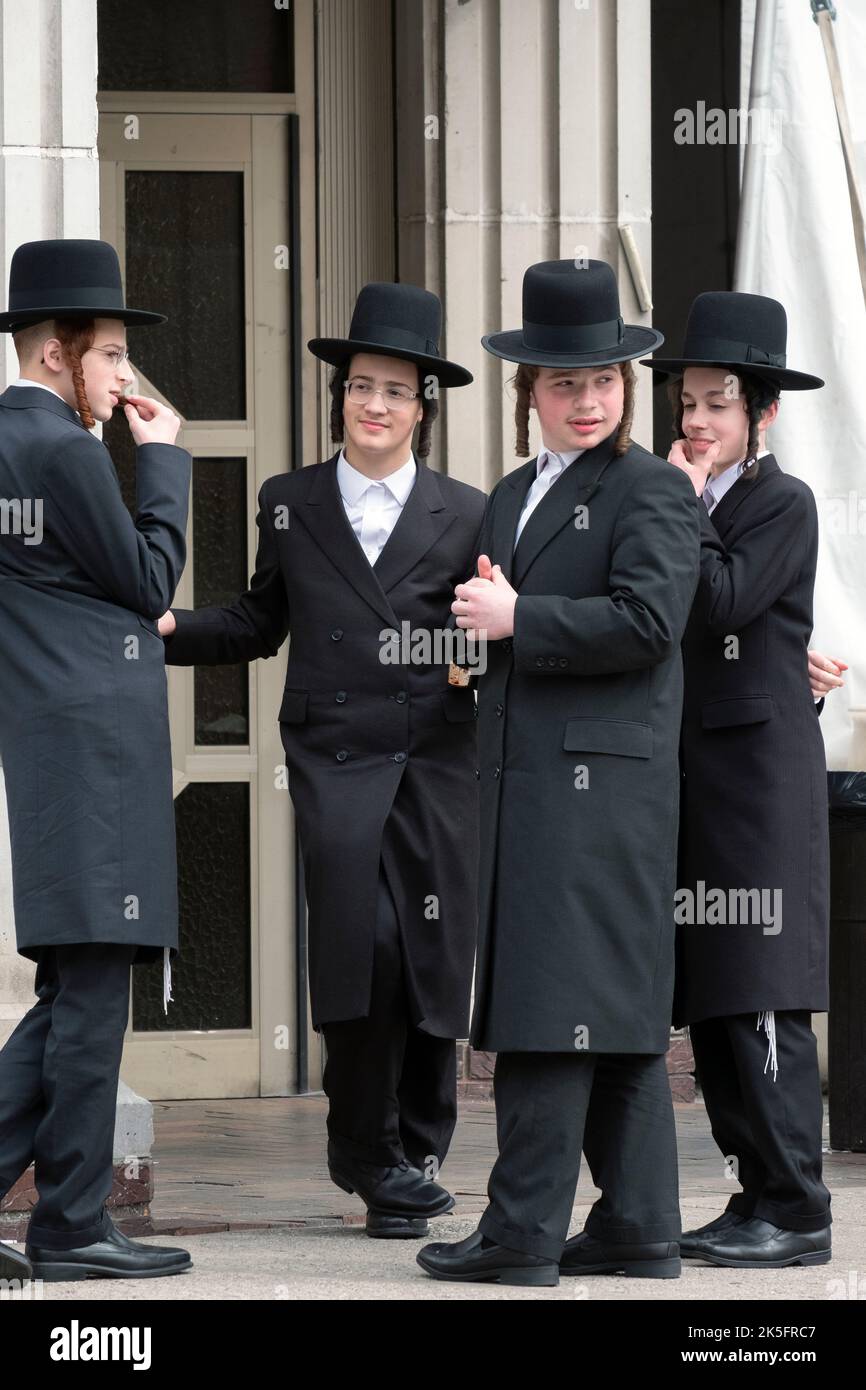 4 hasidic boys dressed in black outside a synagogue in Williamsburg ...